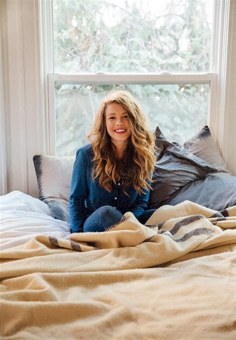 Portrait Of Woman Relaxing On Bed By Stocksy Contributor Trinette