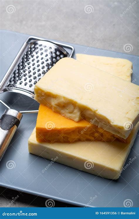 Cheese Collection Matured And Orange Original British Cheddar Cheese In Blocks Served On Grey