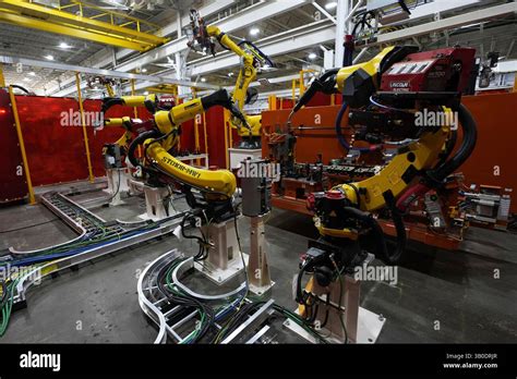 Robotic Arms Are Shown In A Sub Cell Of A Crush Horn Assembly Line At A