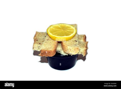 Toast Bread With A Lemon Slice In A Small Bowl Isolated On A White