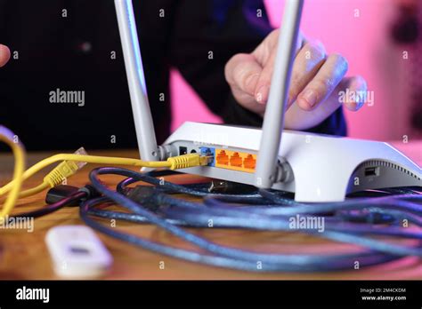Router With Cable Connected Backwards Ports On Person And Colored Background Stock Photo Alamy