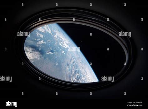 View of Earth from space, looking out from a window of the International Space Station Stock ...
