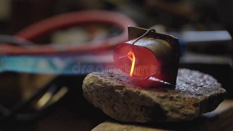 Craftsman Soldering The Tip Of The Scabbard In The Workshop Stock
