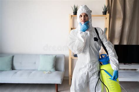 Female Exterminator From Pest Control Service Working Inside House With
