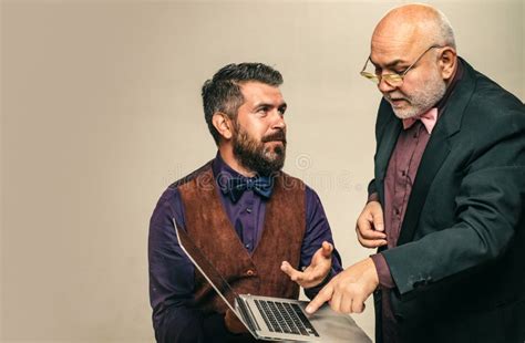 Adult Son And Old Father Using Computer Surfing Internet Together