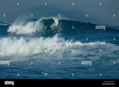 Large Barreling Wave In The Big Sur Coast Of California With A Surfer