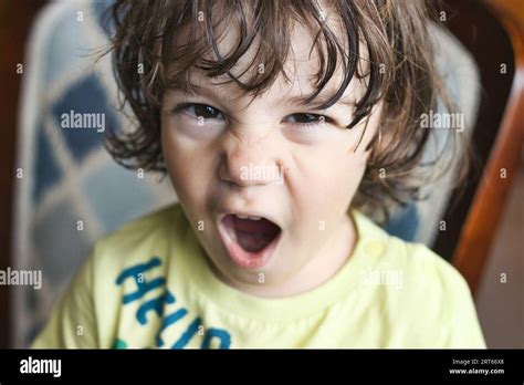 Closeup Headshot Portrait Of A Young White Caucasian Boy Throwing A