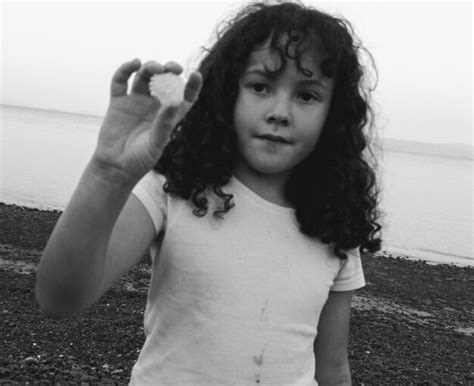 Premium Photo Portrait Of Girl Holding Shell While Standing At Beach