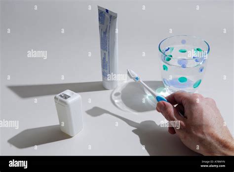 Shadows Of Toothpaste Floss Cup And Hand With Toothbrush For Cleaning