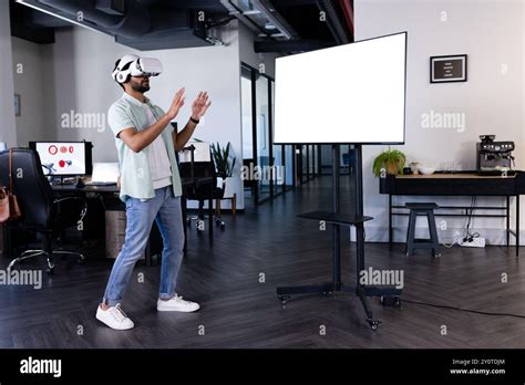 Using Vr Headset Indian Man Interacting With Virtual Display In Modern Office Copy Space Stock