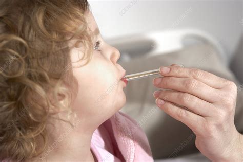 Measuring A Girl S Temperature Stock Image C Science Photo Library
