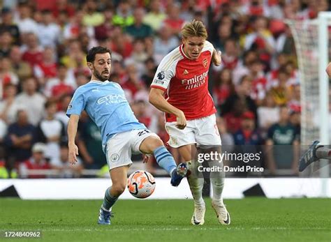 Martin Odegaard Of Arsenal Passes The Ball Under Pressure From News