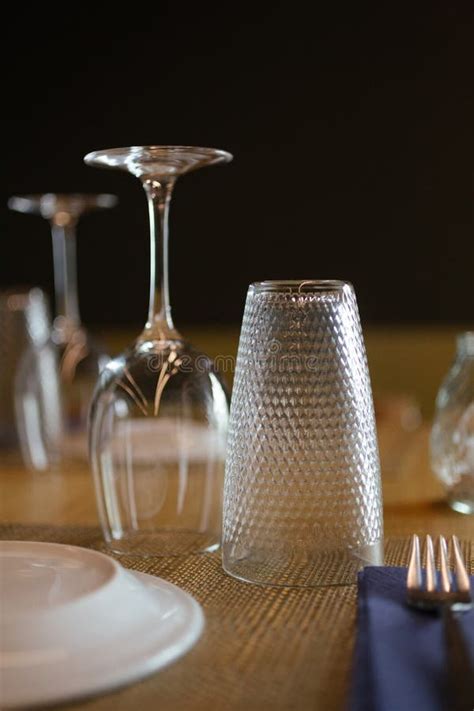 Vertical Shot Of A Wine Glass And A Juice Glass Upside Down On A