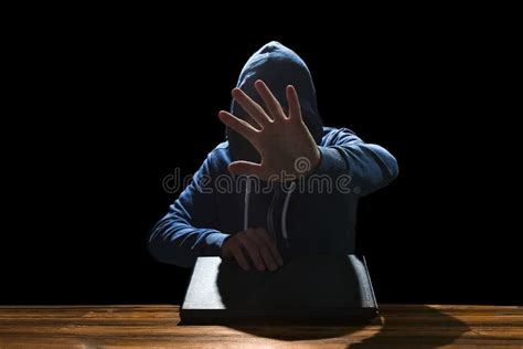 Hacker With Computer Man Sitting At A Table In A Hood Stock Image