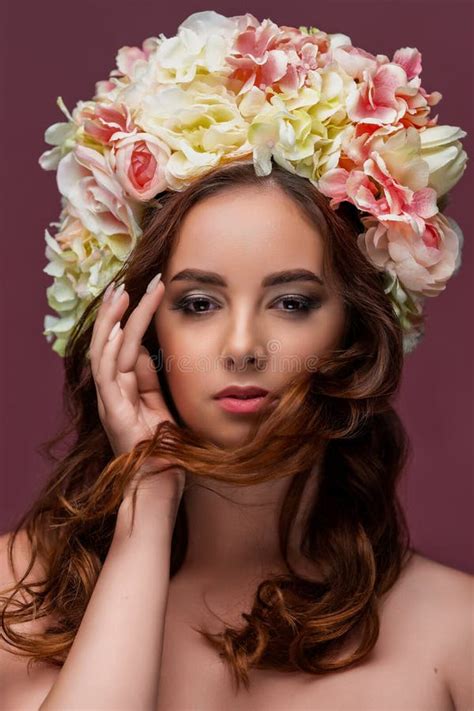 Portrait Of A Beautiful Girl In A Delicate Wreath Of Flowers With Long
