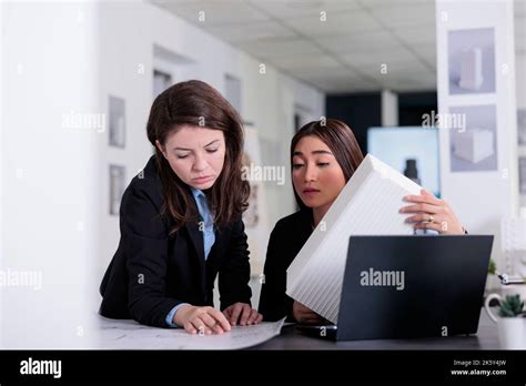 Architects Working With Blueprints Looking At Project Draft Discussing Architectural 3d Model