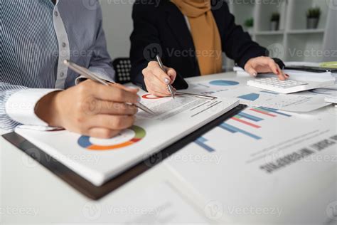 Financial Analysts Reviewing Tax Documents And Data Visualization In A