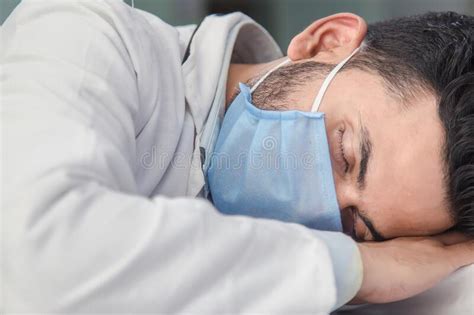 Overworked Female Medical Professional Is Napping On Chair In Hospital