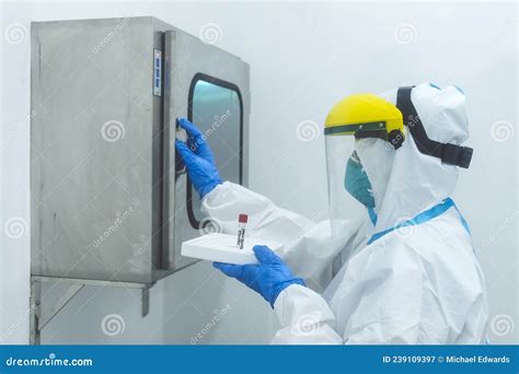 A Medical Technician About To Open A Pass Box To Place A Test Sample At