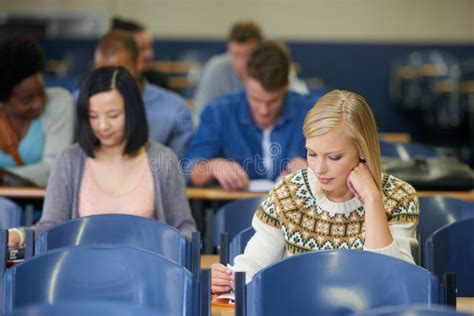 University Class And Students Writing In Lecture Hall And Learning