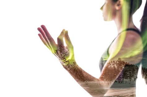 Multiple Exposure Of Meditating Woman Superimposed Over Aurora Borealis