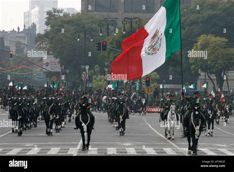 Army Soldiers Wave A Mexican Flag As They Participate In A Parade