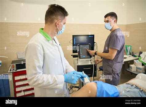 Team Healthcare Professionals Performing Ultrasound Guided Knee