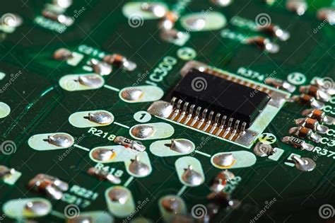 Micro Chip And Capacitors Mounted On A Green Printed Circuit Board