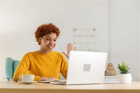 African American Girl Using Laptop Computer Having Video Chat At Home