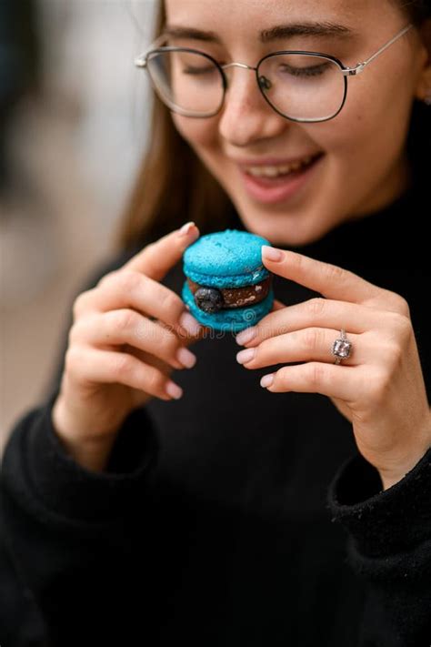 Young Woman Is Going To Eat Sweet Macaroon While Holding It In Her Hand Stock Image Image Of
