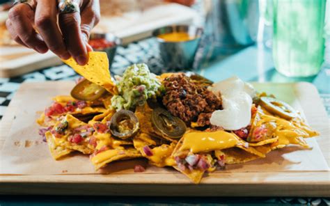 Group Sharing Pub Nachos Prepare To Judge The First Friend To Go