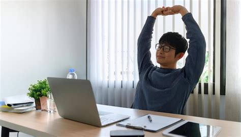 Home Office Setup With Person Stretching Overhead Premium Ai