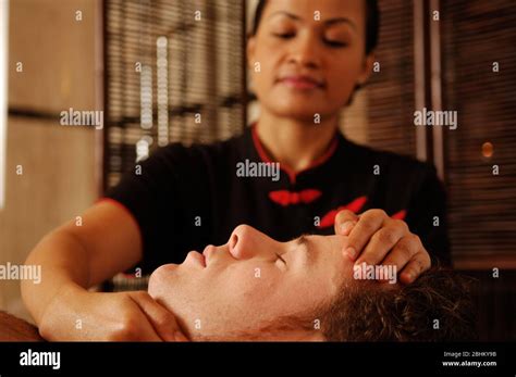 A Man Receiving A Full Head Massage Using Craniosacral Techniques To
