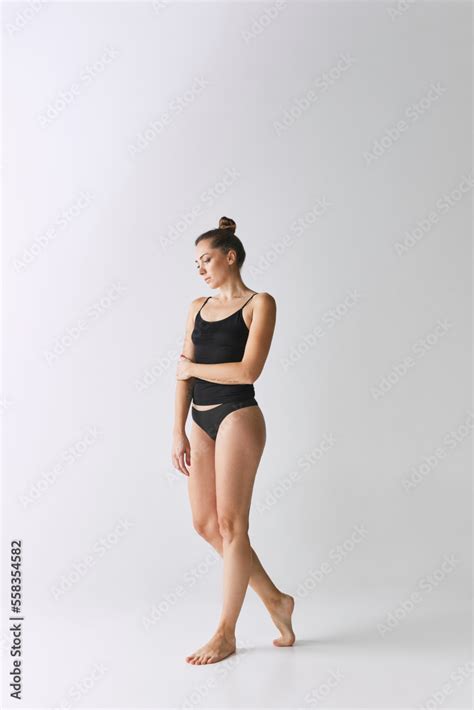 Full Length Portrait Of Slim Beautiful Mature Woman Posing In Black