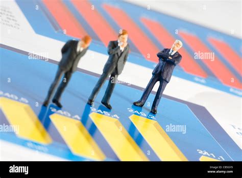Miniature Businessman Analysing A Financial Chart Selective And Soft