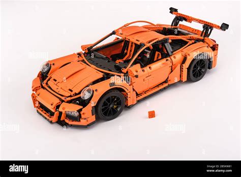 Different Views Of Assembled Orange Lego Porsche Gt 3rs Car With One