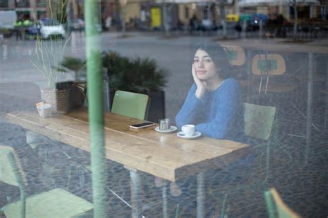 Premium Photo Reflection Of Woman And Coffee On Table In Cafe