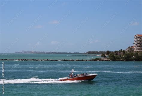 Boat Traveling Fast In The Ocean Water With People Aborad Going Into