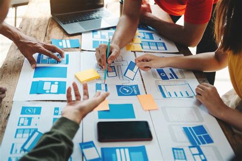 Ux Developer And Ui Designer Brainstorming About Mobile App Interface Wireframe Design With