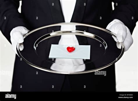 Midsection Of A Man In A Tuxedo Holding A Letter On A Silver Platter Stock Photo Alamy