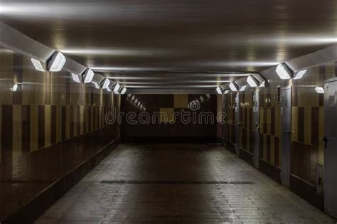 A Modern Urban Underpass With Tiled Walls And Bright Lighting Creating