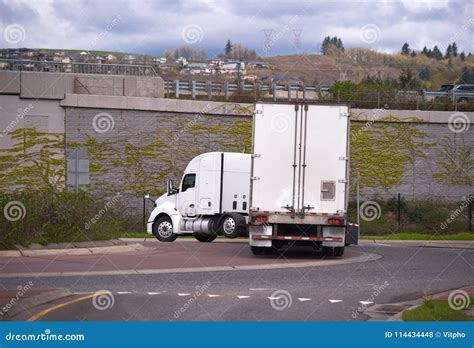 Big Rig Semi Truck With Dry Van Semi Trailer Turning On The Circular