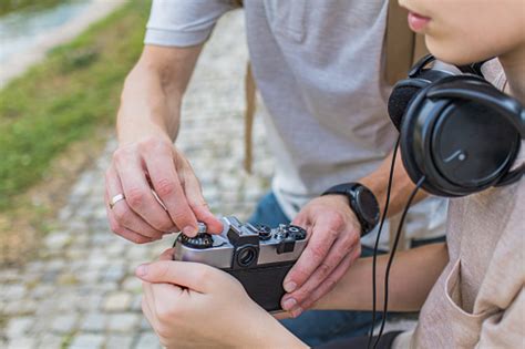 Old Skills Versus New Technology Father Teaching His Son How To Use Retro Photo Camera And How