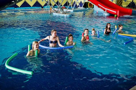 Fitness Group Of Girls Doing Aerobical Excercises In Swimming Pool At