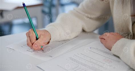 Education Exam And Hands With Test Paper At Desk And Multiple Choice