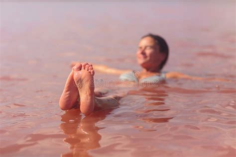Prominent Feet Focus Of Woman In Pink Lake Stock Image Image Of