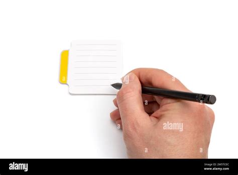 Hand With Pencil Writing On Blank Small Lined Sticky Notes With Yellow