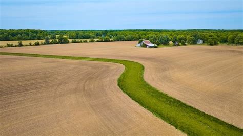 Premium Photo Flat Farmland Terrain With Snaking River Of Green Grass Aerial