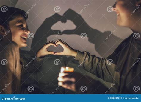 Brother And Sister Playing With Shadows In The Living Room Stock Image
