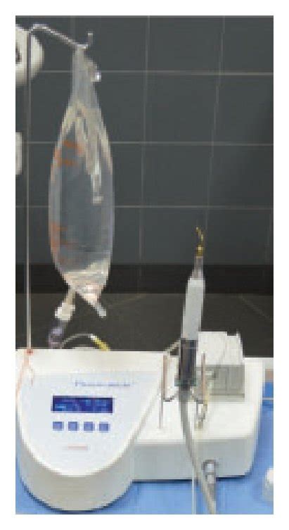 A Piezosurgery Device And B Bone Guttering Around Impacted